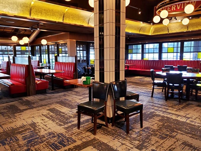 Modern diner elegance with those signature red booths – like your favorite childhood restaurant grew up and got sophisticated.