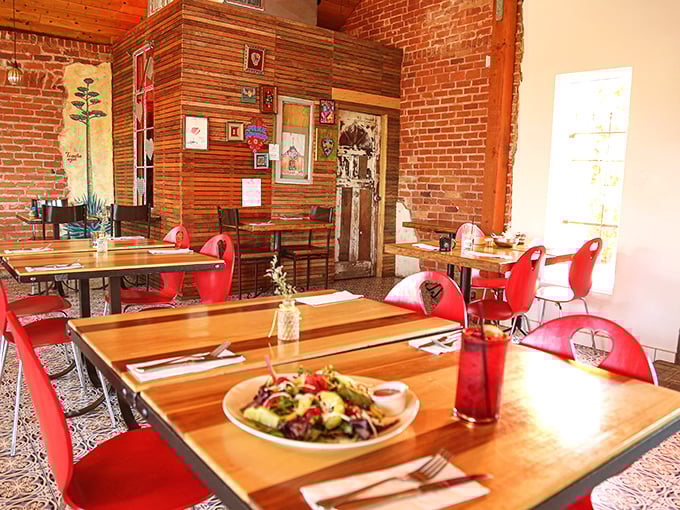 Red chairs pop against wooden tables and exposed brick walls, creating a space that's both energetic and intimate—like dinner with your liveliest friends.