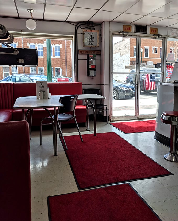 Red booths, red rugs, and a view of small-town America—this entrance has welcomed burger pilgrims for generations.