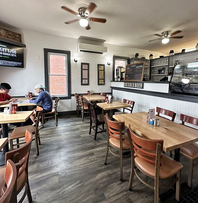 Modern comfort meets classic diner aesthetic—wooden tables, comfortable chairs, and the promise of "COLD BEER" for those post-breakfast return visits.
