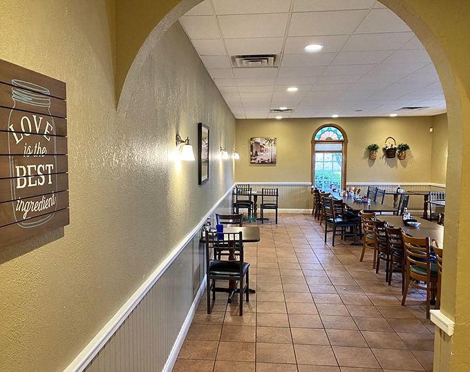 Archways frame this dining space where "Love is the best ingredient" isn't just wall art—it's the restaurant's operating philosophy.
