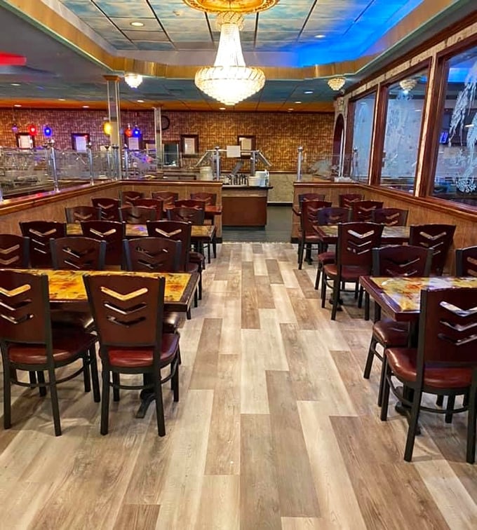 Light streams across polished wood floors while chandeliers cast a warm glow. Buffet dining with unexpected elegance.