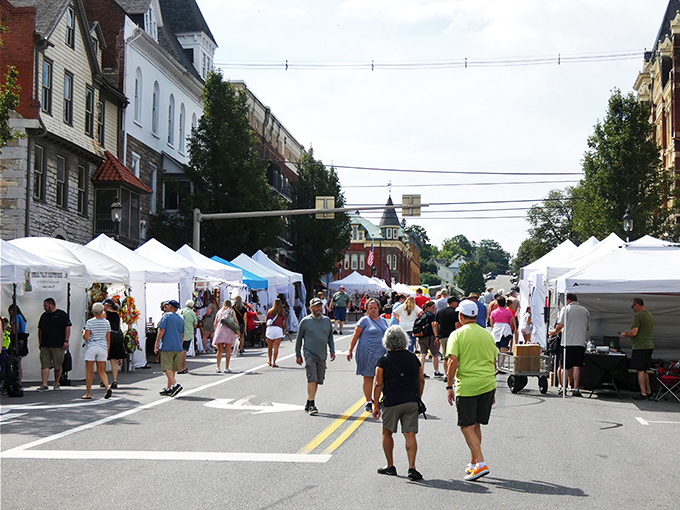 The Arts & Crafts Fair transforms streets into pedestrian-only creative havens. White tents filled with treasures made by actual human hands.