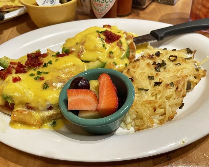 The Avocado Tomato Benedict performs a delicate balancing act – rich hollandaise and creamy avocado finding perfect harmony with bright, acidic tomatoes.