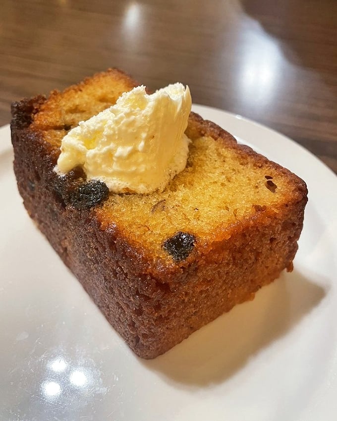Banana bread that walks the perfect line between cake and bread, topped with a pat of butter that's slowly creating a golden puddle.
