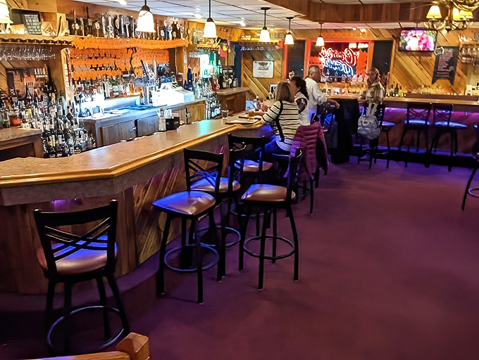 The classic bar setup invites pre-dinner cocktails and post-meal conversations that extend well into the evening hours.