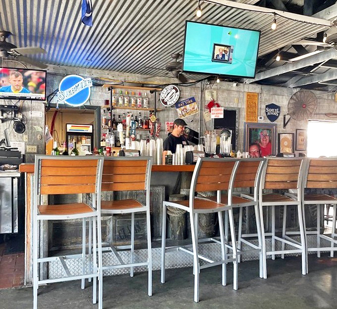 The bar area, with its weathered wood and corrugated metal ceiling, serves up drinks with a side of coastal character and zero pretension.