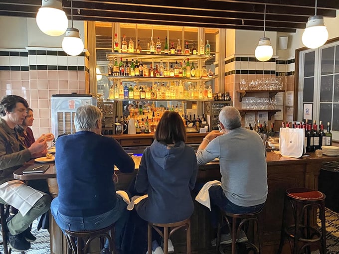 The bar at The Love—where strangers become friends and friends become family. That backlit bottle display isn't just storage, it's a promise.
