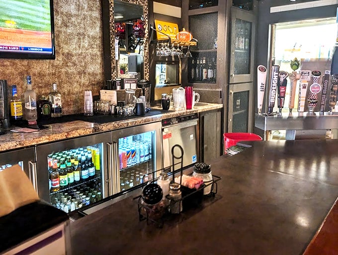 The bar setup isn't trying to be trendy or Instagram-worthy – it's focused on the timeless art of serving cold drinks alongside hot pizza.