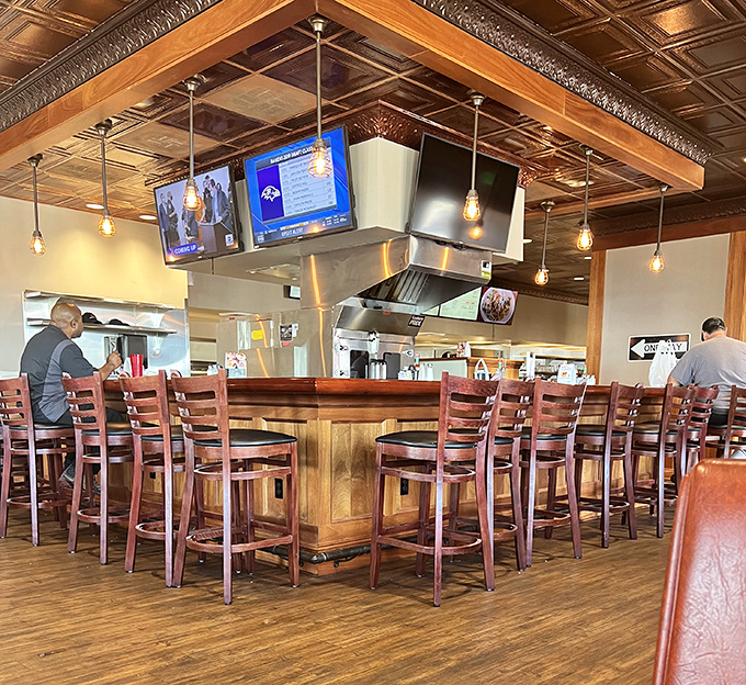 The bar area—where sports on TV and comfort food on plates create the perfect formula for happiness. Einstein would approve.