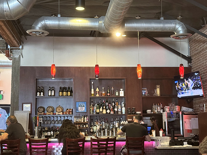 The bar isn't just serving drinks—it's facilitating pizza appreciation ceremonies. Wine and beer: pizza's favorite dance partners.