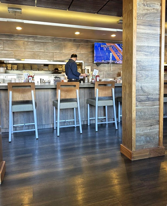 The bar area glows with promise – where diner comfort meets cocktail hour sophistication in perfect harmony. 