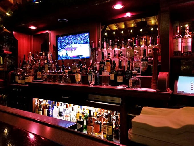 The glow behind the bar bottles creates a warm amber beacon for thirsty travelers. Like a lighthouse, but guiding you toward Manhattan perfection instead of safe harbor.