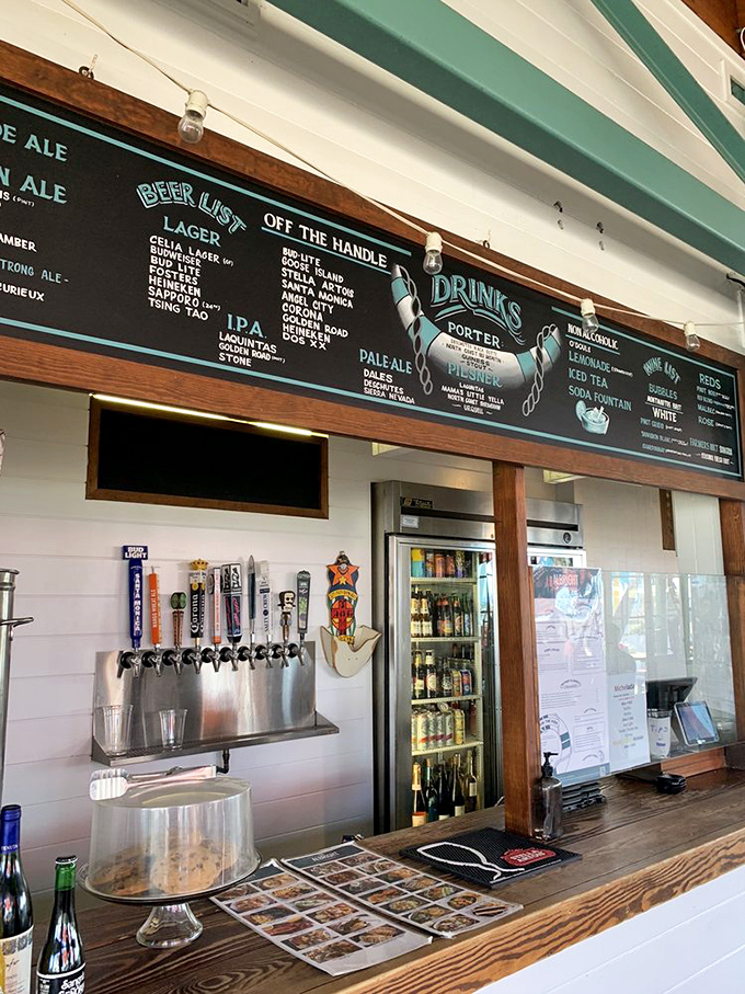 The bar—where beer taps flow like poetry and the wooden counter holds stories of countless seafood celebrations.