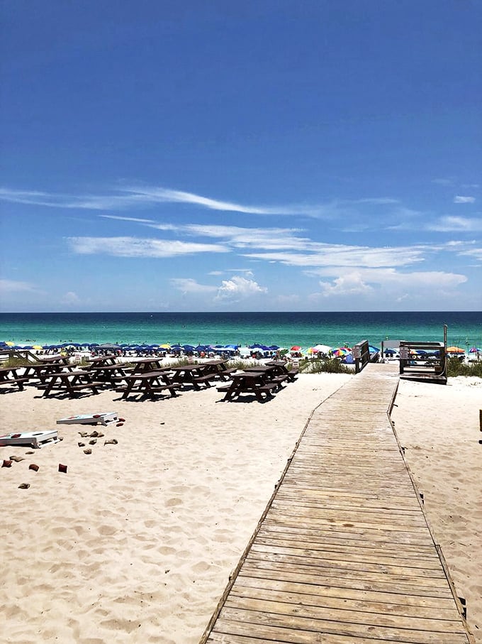 This wooden walkway isn't just a path to the restaurant—it's the yellow brick road of seafood pilgrimages.