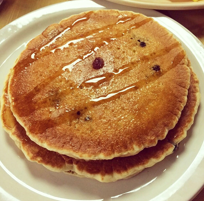 Pancakes with personality – golden brown with blueberries that burst like tiny flavor bombs. Add maple syrup and watch breakfast become an event.