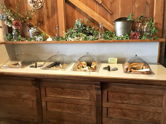 A bread station that whispers sweet carbohydrate promises to everyone who passes by its golden offerings.