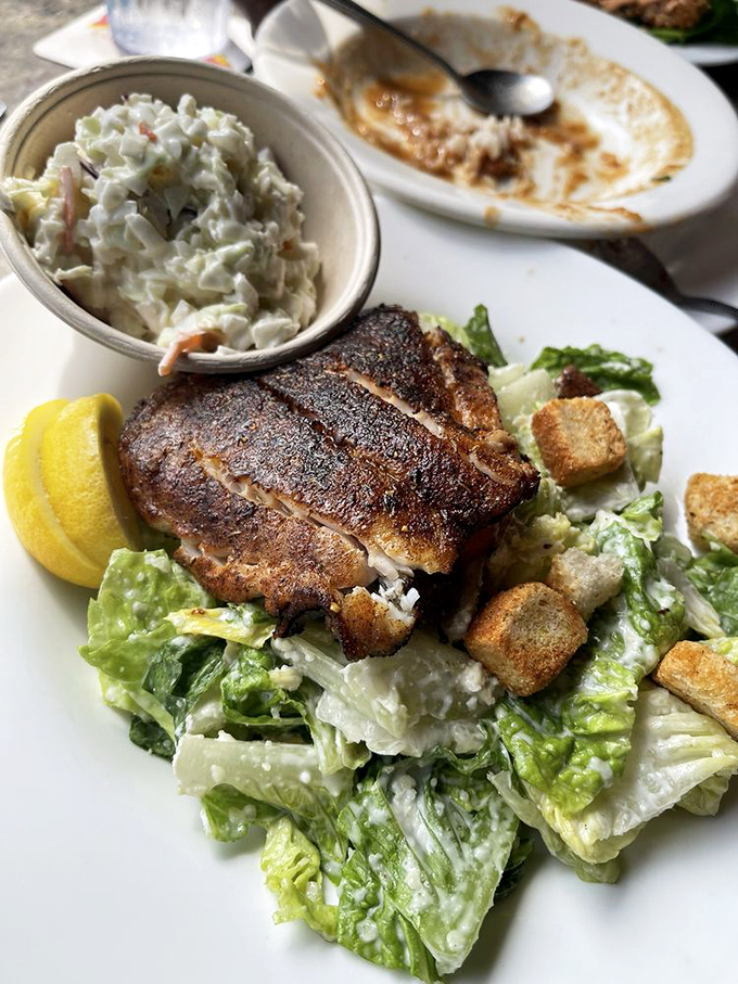Blackened fish atop Caesar salad—where healthy meets heavenly. The fish is so fresh it practically jumped from the Gulf onto your plate.