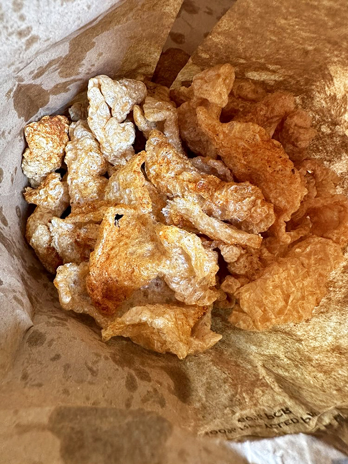 These aren't just pork rinds—they're cloud-like crisps of porky perfection that shatter with a satisfying crunch before melting away.