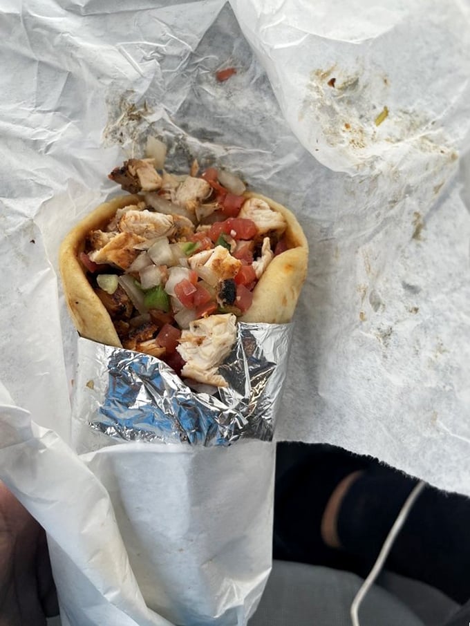 This wrap isn't just food—it's a portable feast. Fresh ingredients peeking out like they're trying to introduce themselves before being devoured.