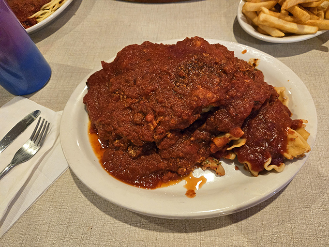 Chicken parmesan that doesn't know the meaning of restraint – a mountain of sauce and meat that requires both commitment and napkins.