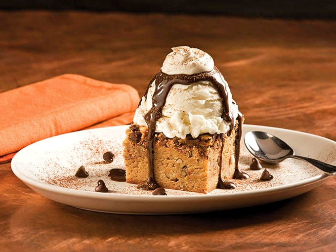 A warm chocolate blondie crowned with ice cream and chocolate sauce – dessert architecture that deserves both a photo and your undivided attention.