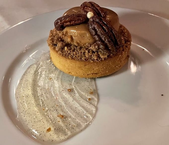 This dessert isn't just served; it's presented—a pecan tart that's dressed better than most people at a wedding.