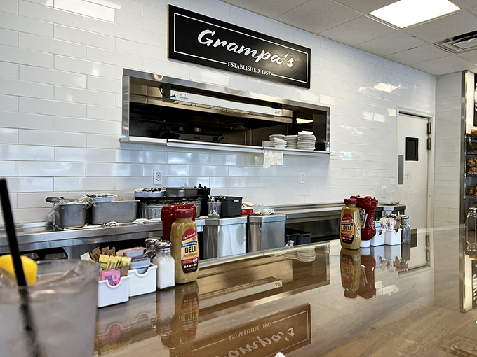 Behind this counter, culinary magic happens with clockwork precision. The white subway tiles aren't just trendy—they're a backdrop for breakfast theater. 