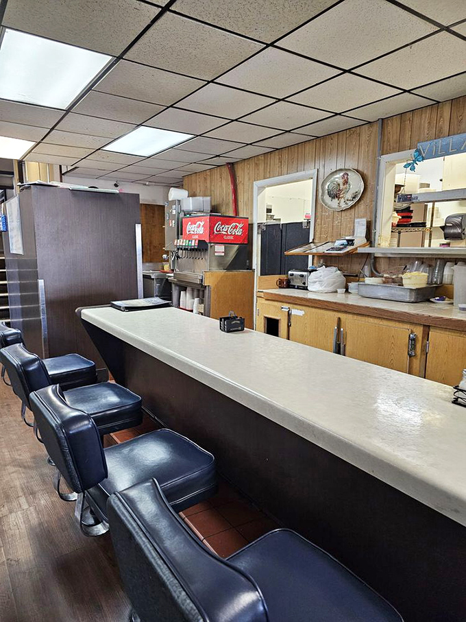 The counter where breakfast dreams come true. Those stools have witnessed countless coffee refills and life-changing food decisions.
