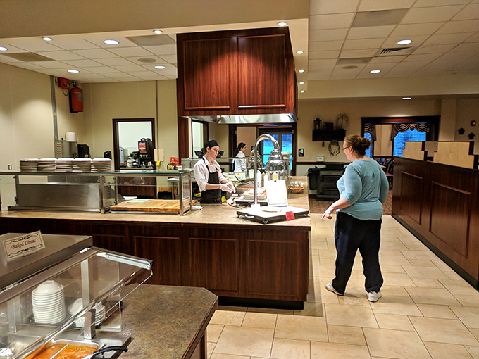At the serving counter, where culinary magic happens in plain sight, staff prepare to welcome hungry guests to their kingdom of comfort food.