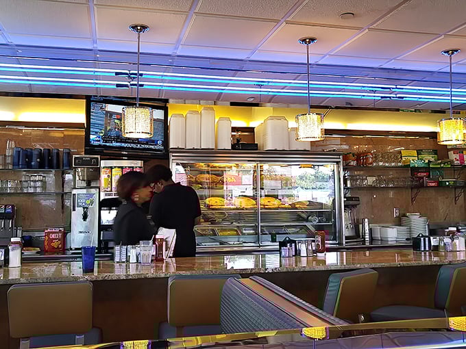 The counter and bakery display—where willpower goes to die and "I'll just have coffee" turns into "and a slice of that cake, please."