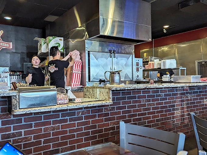 A glimpse behind the BBQ curtain. The staff works with the focused precision of people who know they're creating something worth waiting for.