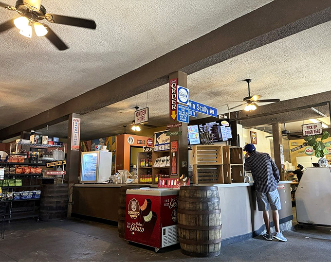 The ordering counter—where dreams become reality. That "ORDER HERE" sign might as well say "HAPPINESS BEGINS HERE" for those in the know.