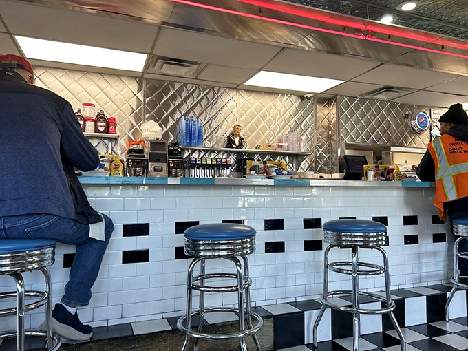The counter seats—where solo diners become temporary family and the short-order ballet unfolds before your appreciative eyes.