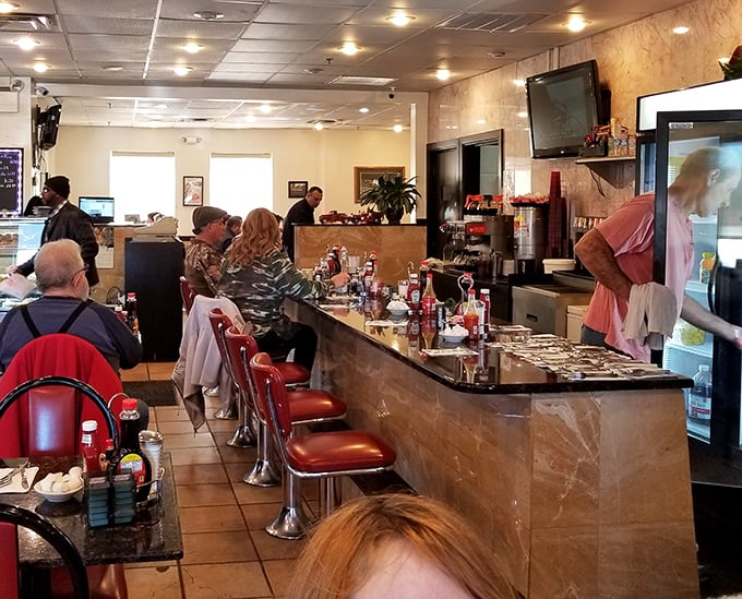 Where strangers become neighbors over eggs and coffee. The counter—democracy's last great stronghold where doctors sit beside mechanics.