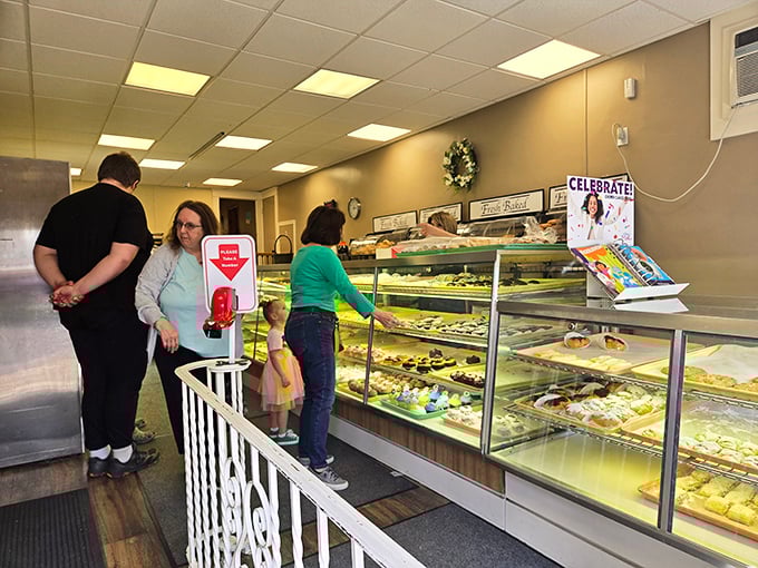 Customers navigate the bakery's offerings with the serious concentration of art collectors at an auction – each selection a potential masterpiece.