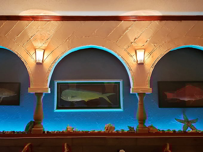 Fish artwork illuminated by aqua lighting creates an underwater ambiance that reminds you exactly where tonight's dinner recently resided.