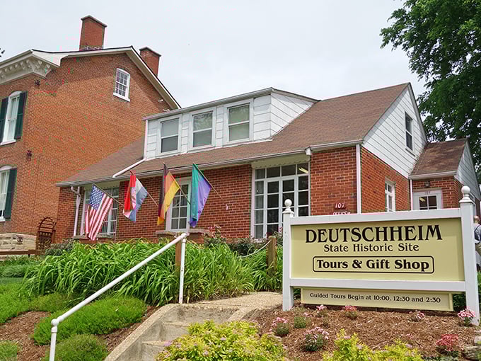 The Deutschheim State Historic Site welcomes visitors with international flags and guided tours, preserving the German immigrant experience for future generations.