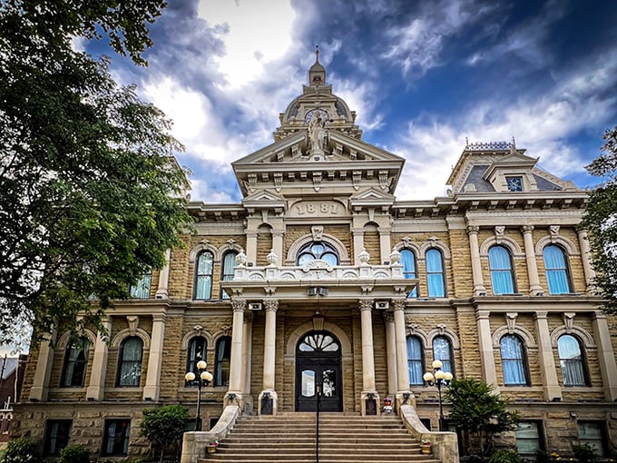The Guernsey County Courthouse stands majestically against dramatic skies, like architecture's version of a power ballad—complete with ornate flourishes that refuse to apologize for their grandeur.