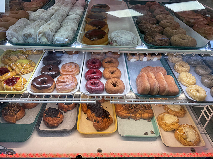 The donut display case – where willpower goes to die and breakfast dreams come true.