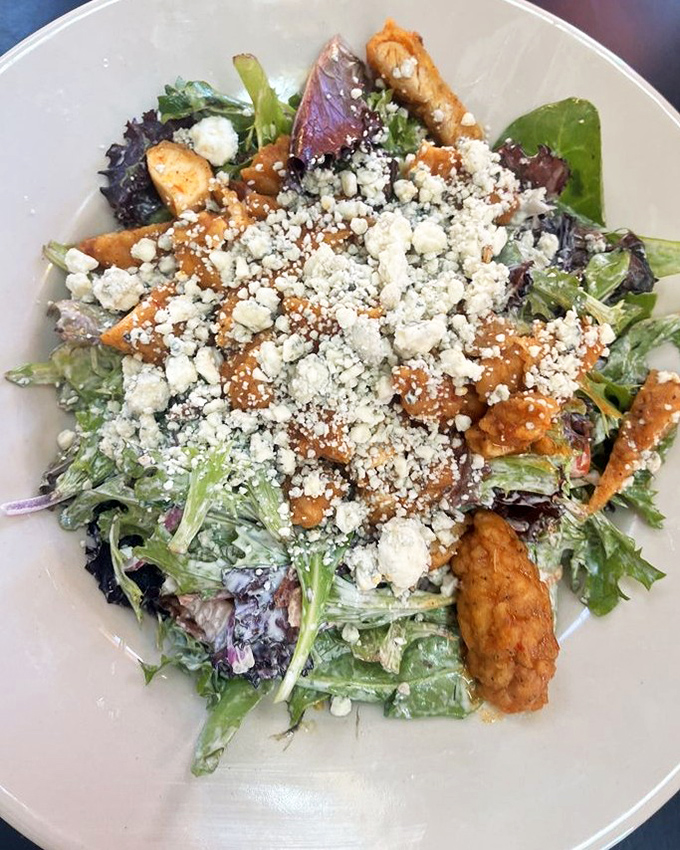 This isn't just a salad, it's a peace treaty between health food and comfort food—crisp greens, buffalo chicken, and blue cheese finding delicious common ground.