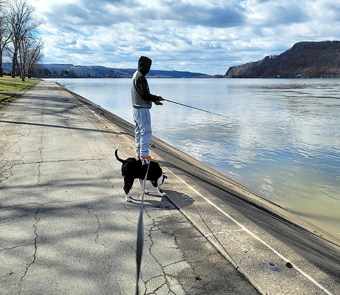 Man's best friend joins the timeless ritual of riverside fishing. Some days it's about the catch; most days it's about the peace.