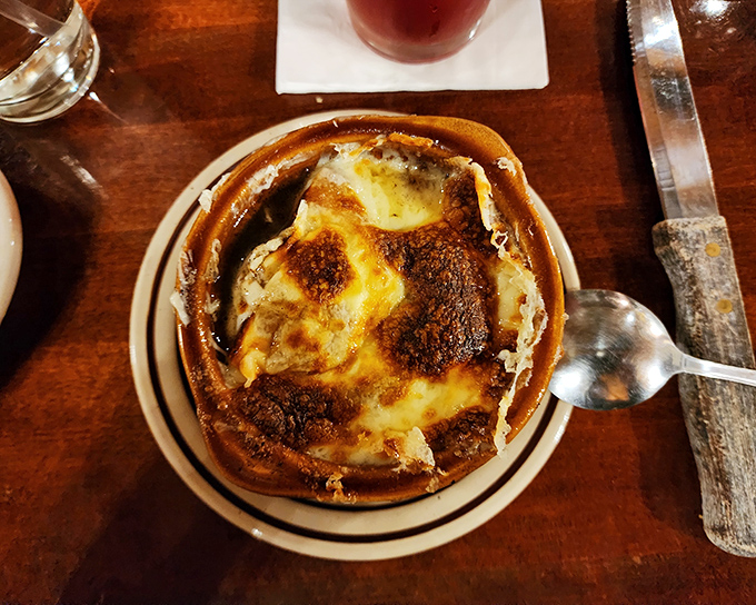 French onion soup bubbles under a blanket of bronzed cheese—a timeless appetizer that's worth the inevitable string of cheese stretching from bowl to mouth.