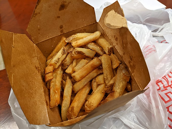 French fries so perfectly golden they deserve their own Olympic medal. Crispy on the outside, fluffy within—the supporting actor that steals the show.
