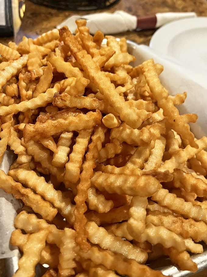 Crinkle-cut fries that look like they're wearing corduroy pants. Crispy on the outside, fluffy inside—the mullet haircut of side dishes.