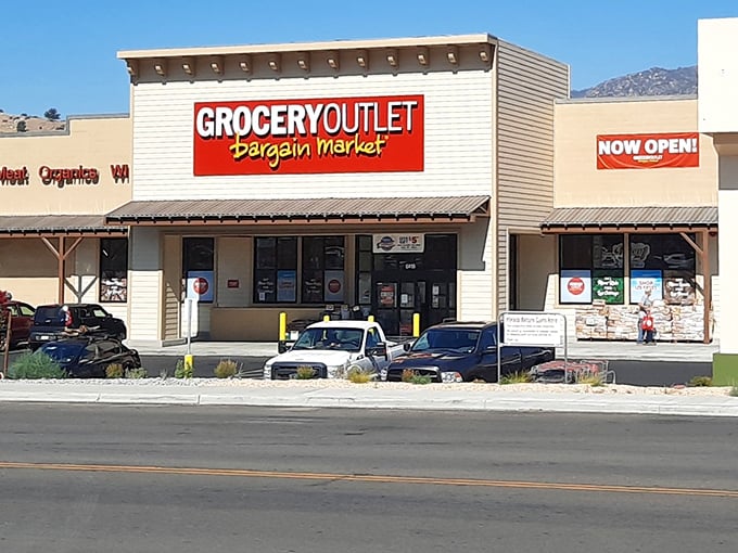 The Grocery Outlet sign promises what retirees love most: bargains with a side of mountain scenery thrown in for free.