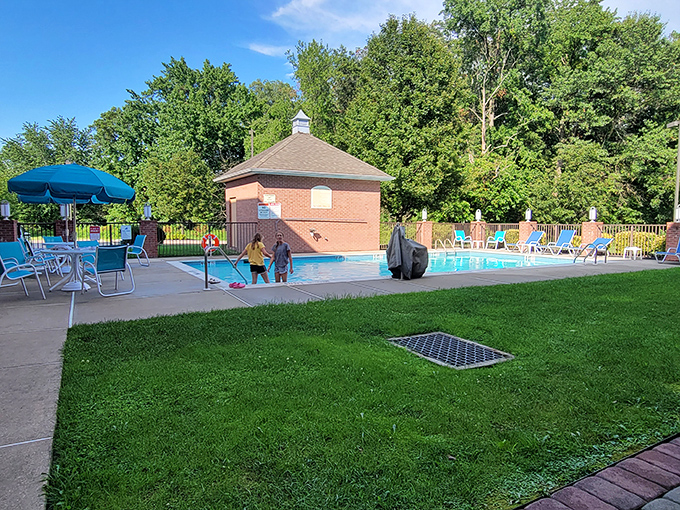 The community pool offers summer respite for families seeking affordable recreation. Those blue chairs have witnessed countless "watch this, Mom!" moments.