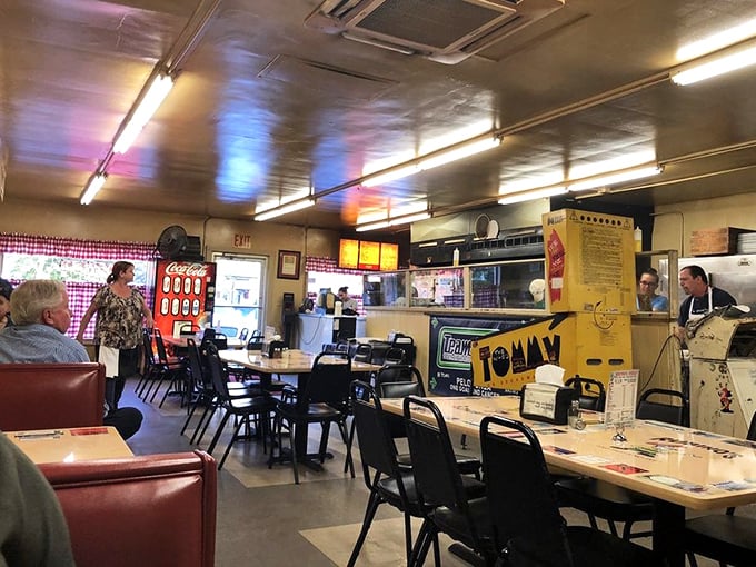 The vintage Coca-Cola machine isn't retro decor—it's a survivor from an era when dining out meant disconnecting from everything except the people at your table.
