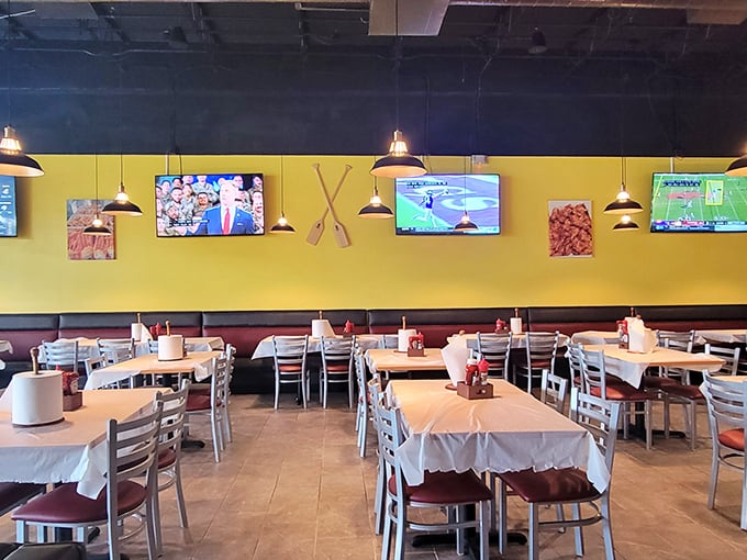 Yellow walls and TVs create the perfect casual backdrop for serious eating. This isn't dinner theater—it's dinner as the main event.