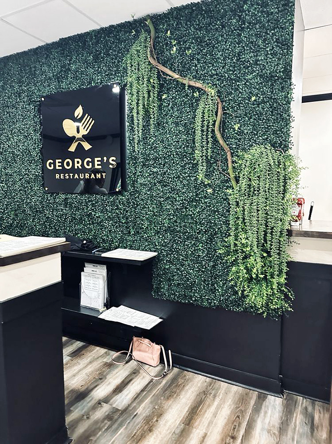 The stylish green wall with George's logo creates an Instagram moment that says, "Yes, I've discovered the place locals have been trying to keep secret."